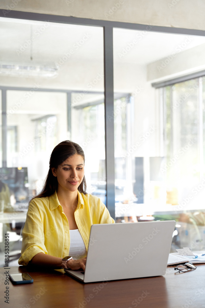 Young woman employee using computer for business work. Smiling latin ...