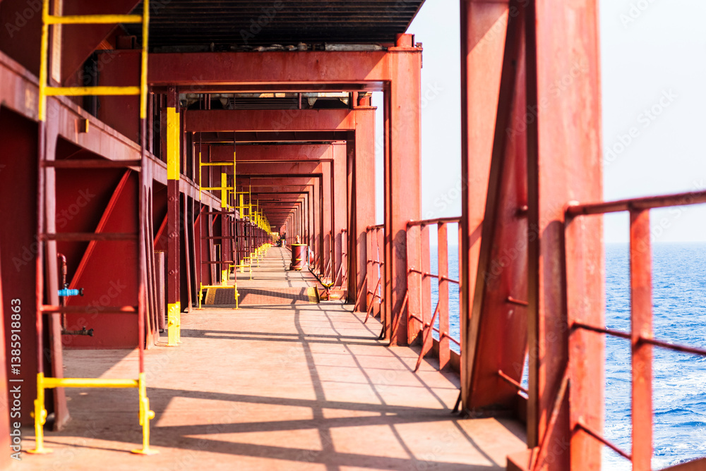 Cargo container ship deck walkway, under loaded containers with cargo ...