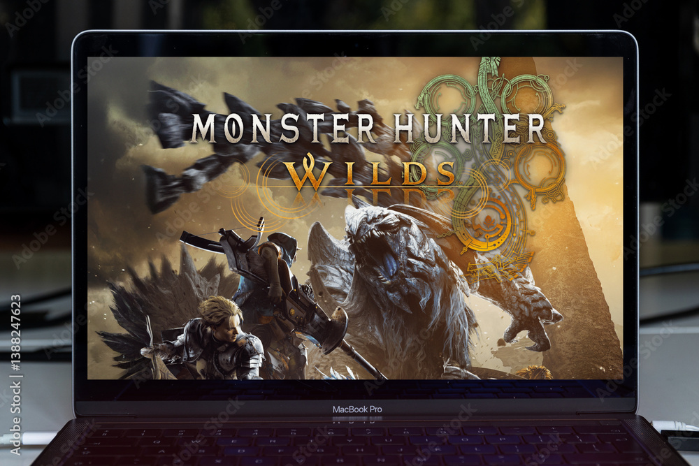 Monster Hunter Wilds game title screen displayed on a MacBook Pro ...