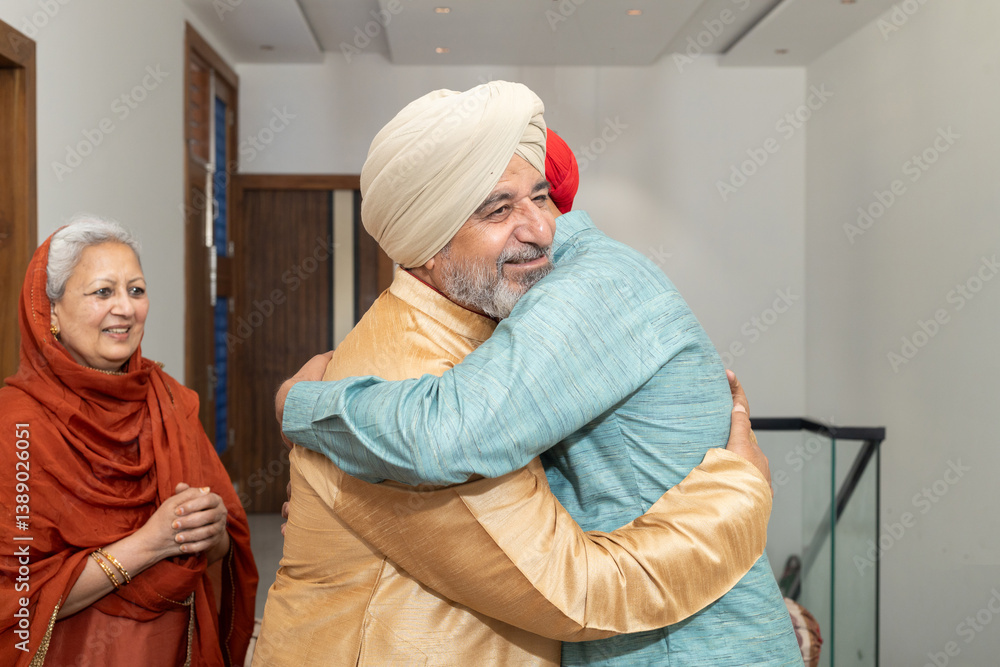 Punjabi sikh father and son hugging and greeting on lohri or baisakhi ...