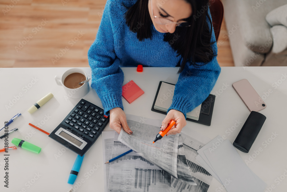 Accountant reviewing financial reports and highlighting important data ...