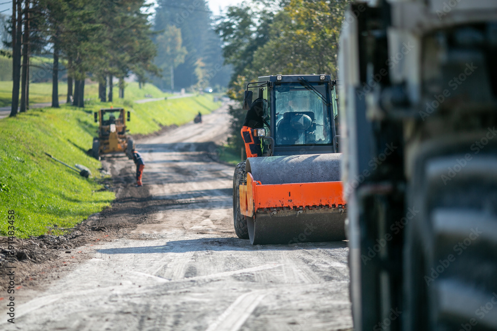 Road compactor roller compacting gravel for new asphalt road with ...