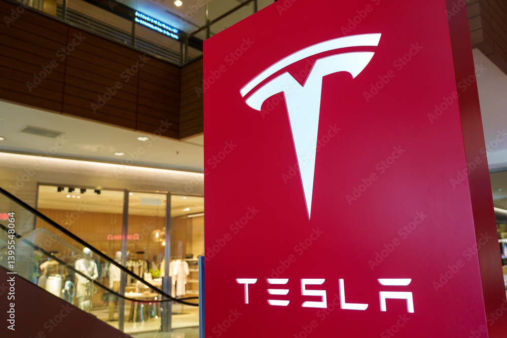 Penang, Malaysia – Mar 26, 2025: Prominent Tesla logo on a red display ...