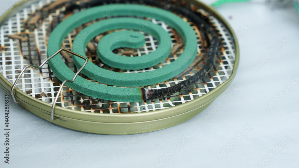 Burning green spiral mosquito repellent coil and red fire with white ...