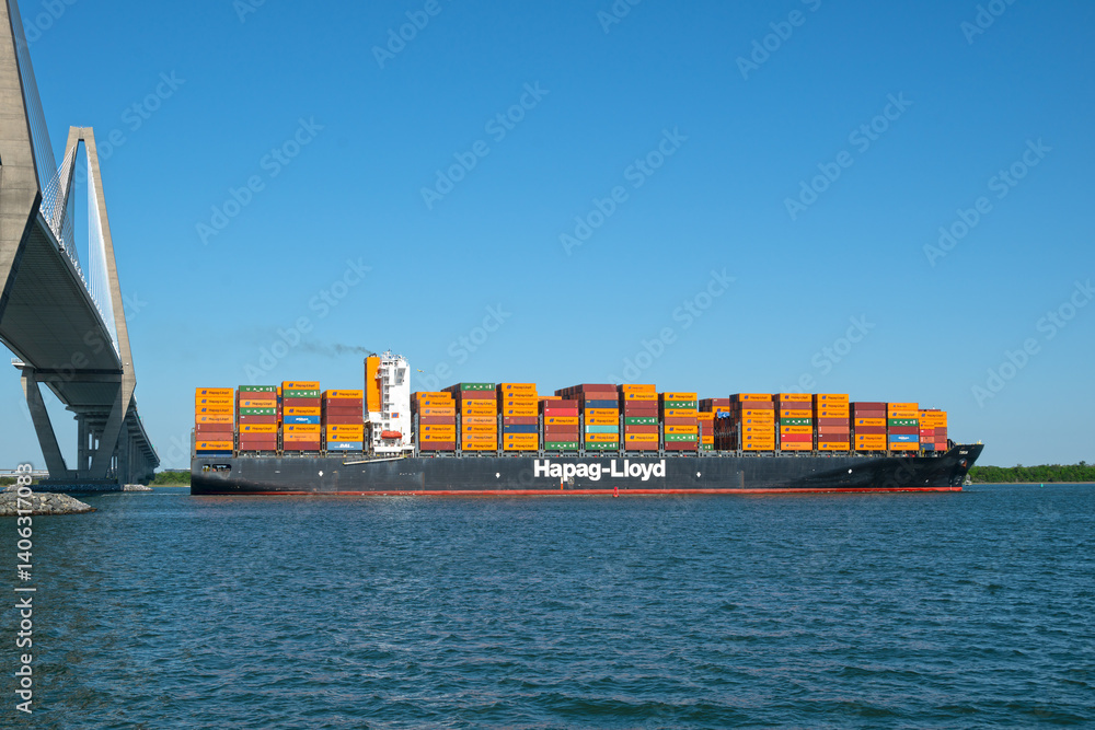 Hapag-Lloyd Neo Panamax-class container ship Tirua passes under the Ravenel Bridge as it sails ...