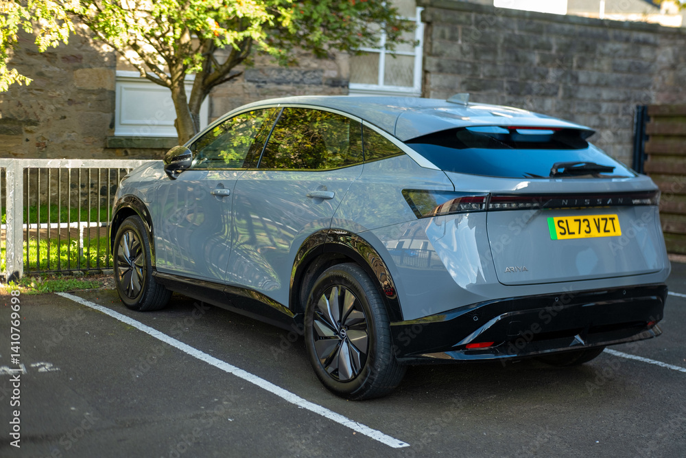 Gray Nissan Ariya parked on street, modern electric vehicle, modern car ...