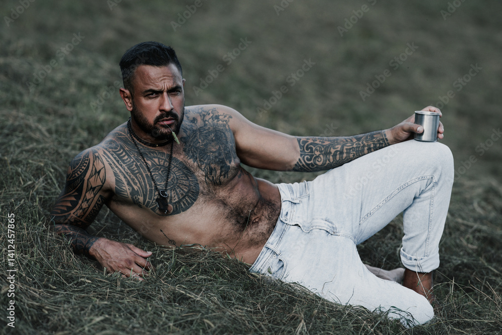 Shirtless man sitting in a sunlit field. Muscular shirtless guy on ...