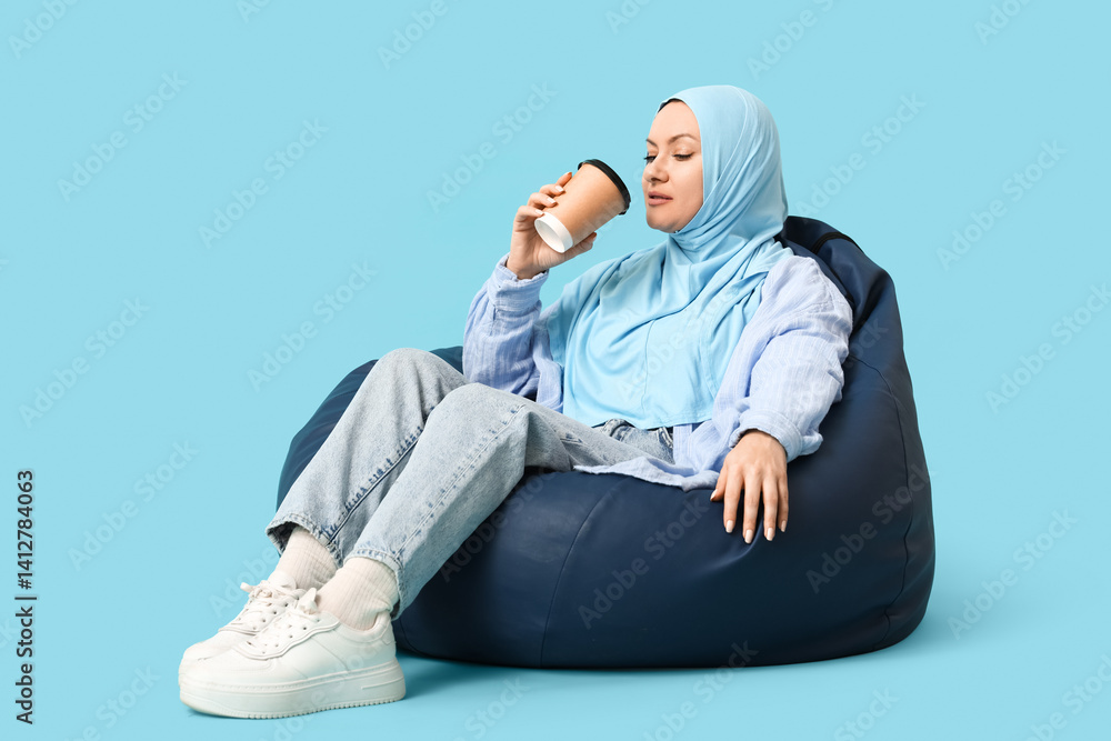 Beautiful Muslim woman in hijab with paper cup of hot coffee sitting on ...