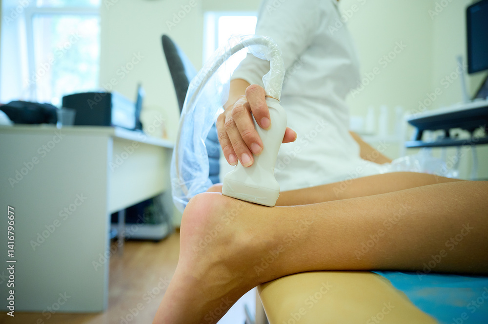 Pediatric ultrasound scan. Child ultrasound. Pediatrician scanning leg ...