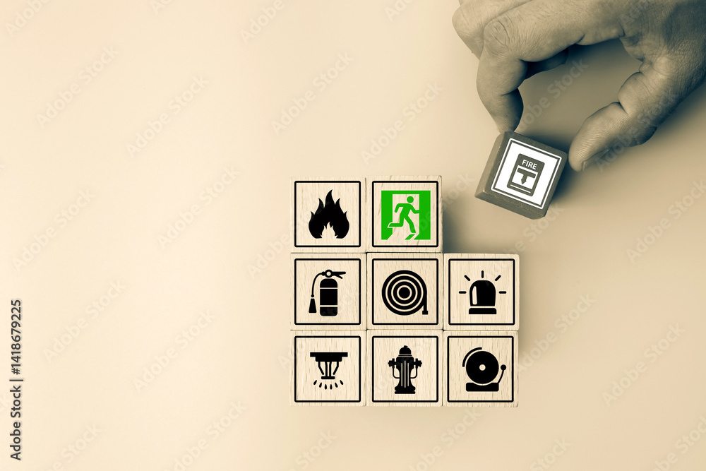 Hand chooses door exit sing on wooden toy block stack for fire escape ...