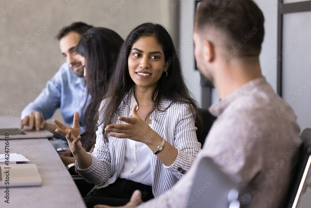 Indian woman engaged in conversation with male colleague, confidently ...