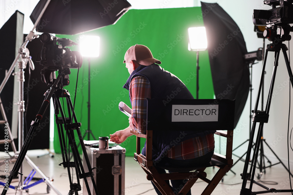 Movie director sitting on chair in modern film studio, back view Stock ...