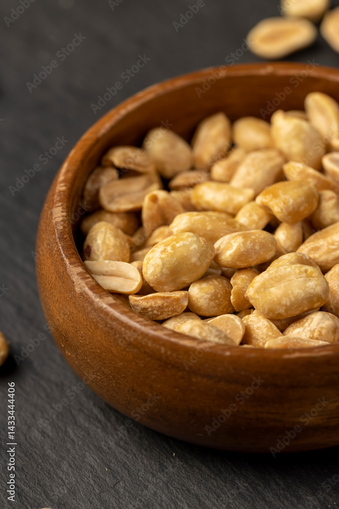 peeled and roasted peanuts in a wooden bowl, crunchy peanuts without ...
