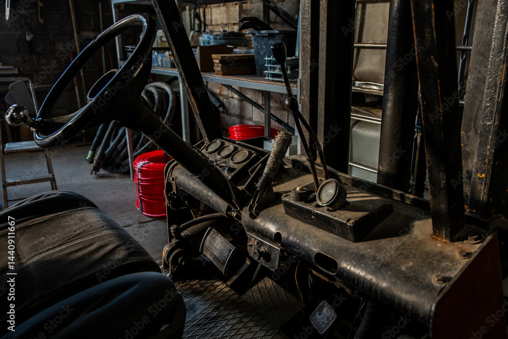 Weathered forklift interior showing steering wheel, control levers, and ...