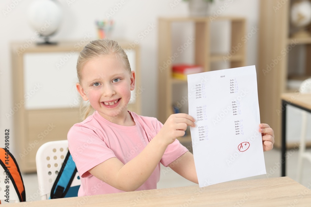 School grade. Happy girl holding answer sheet with letter A and plus ...