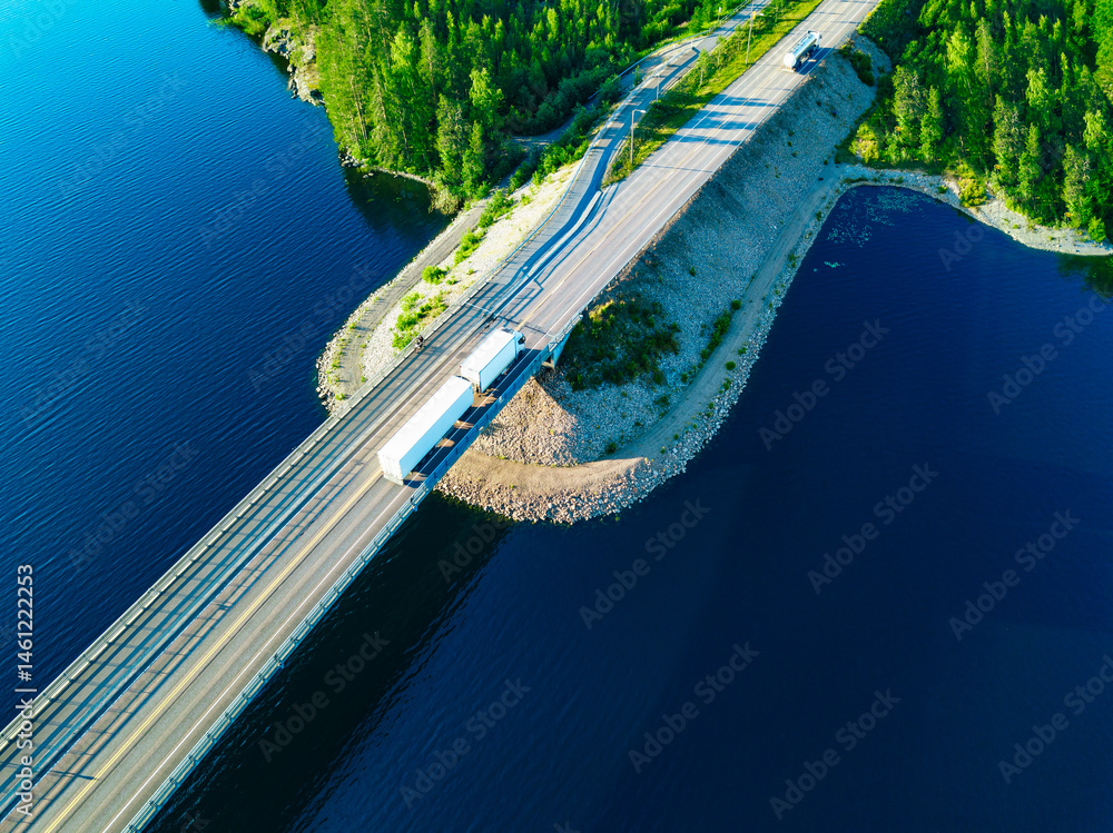 Aerial view of cargo truck and fuel tanker truck driving on asphalt ...
