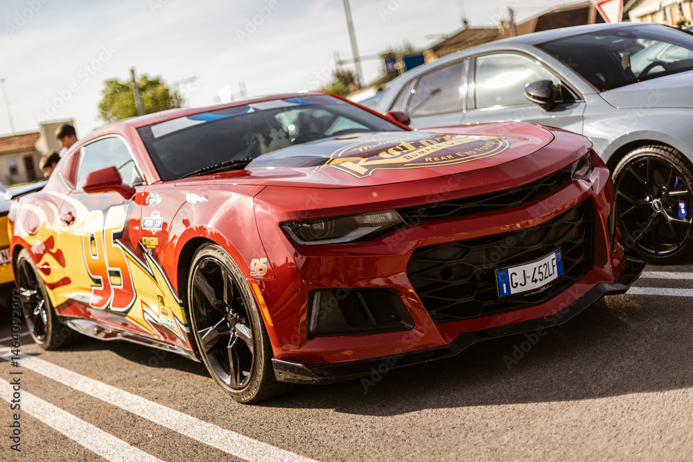 Red chevrolet camaro parked showing lightning mcqueen livery from ...