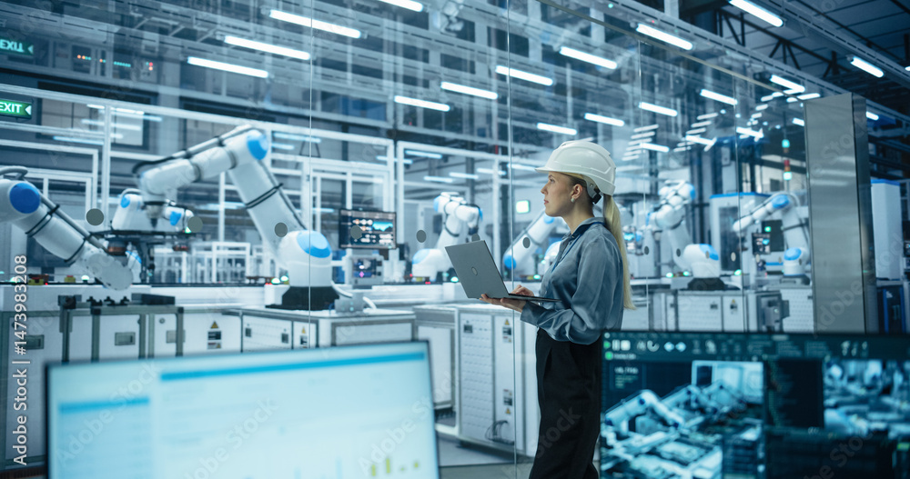 Electronics Factory Manager Working on Laptop at an Industrial ...