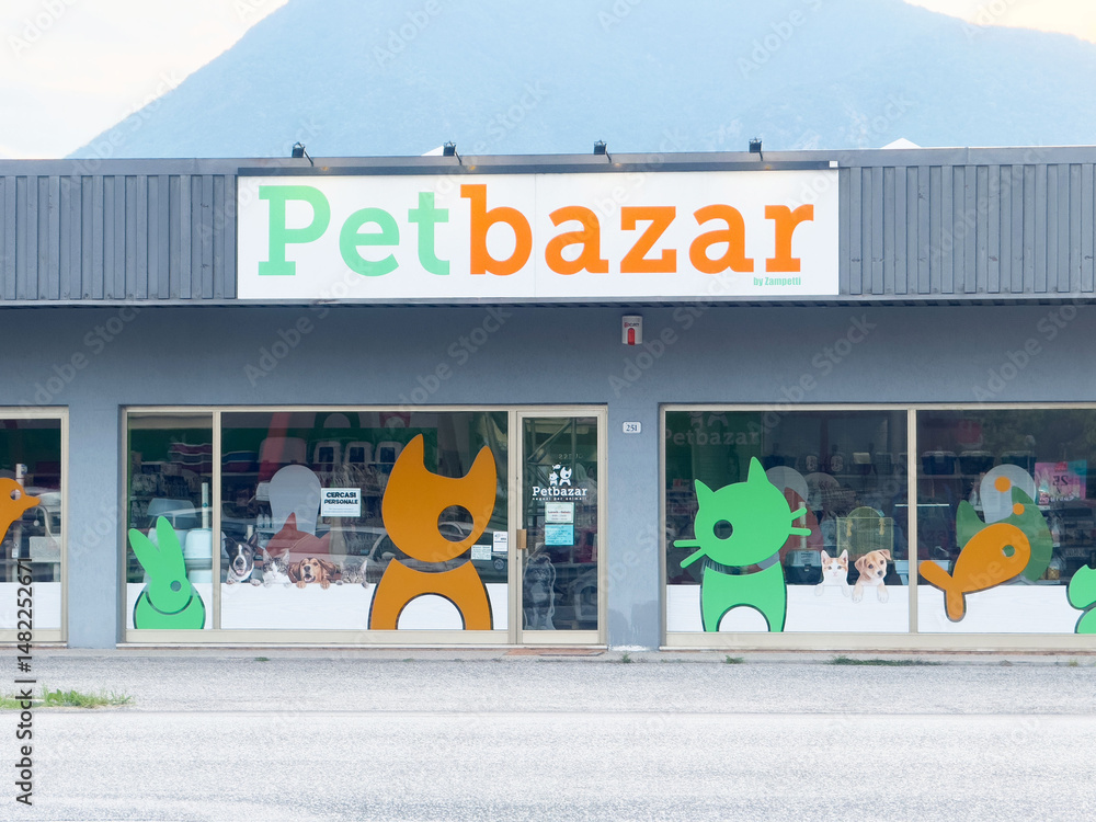Pet bazar storefront with colorful animal graphics against mountain ...