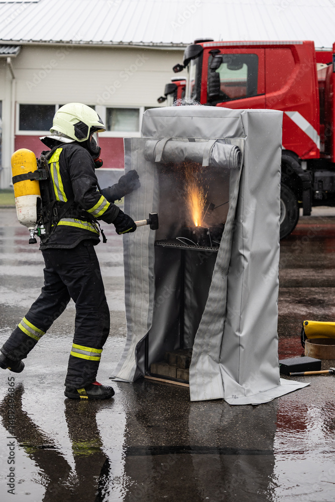Firefighter in full gear creates sparks while cutting metal inside a ...