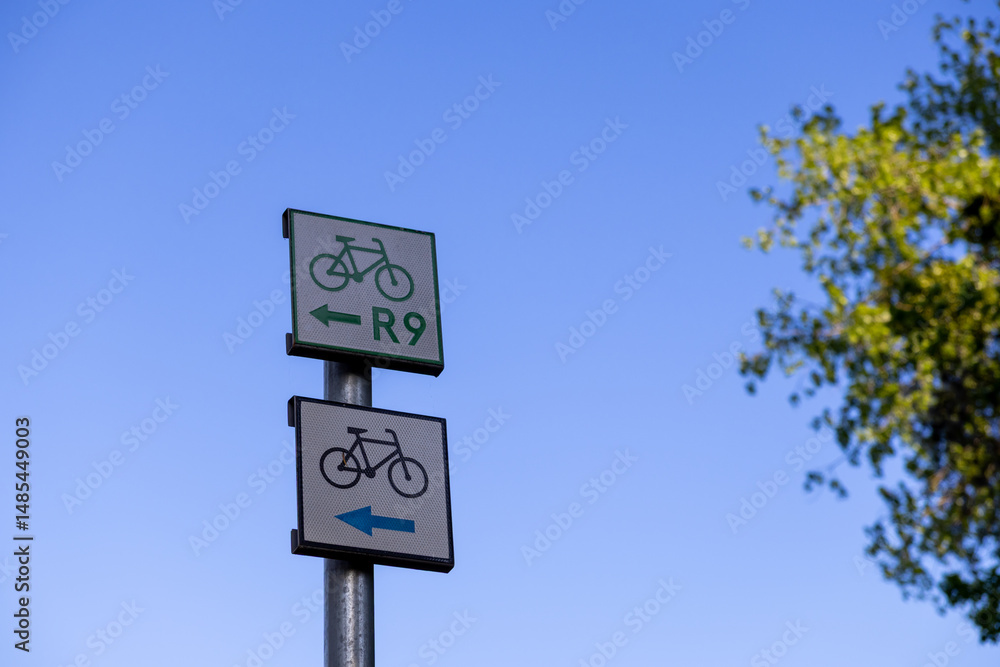 Vertical cycling route signs displaying bicycle icons and arrows with ...