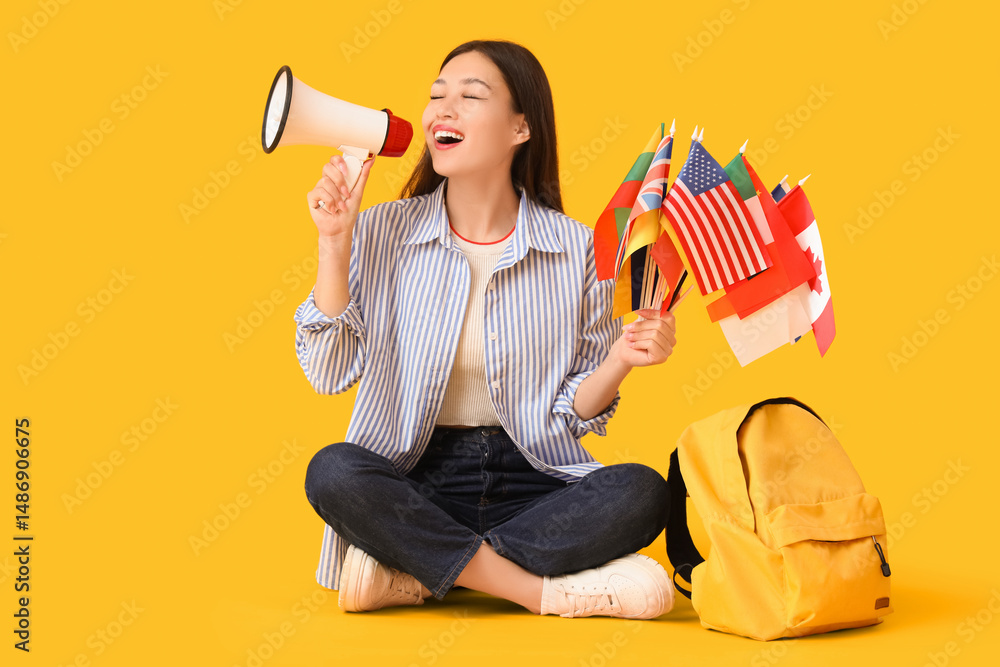 Female Asian student with flags of different countries and megaphone on ...