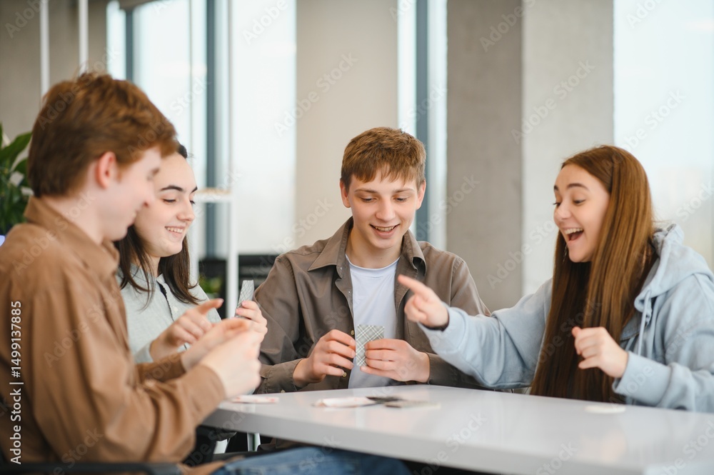 Happy students playing cards and having fun at school Stock Photo ...