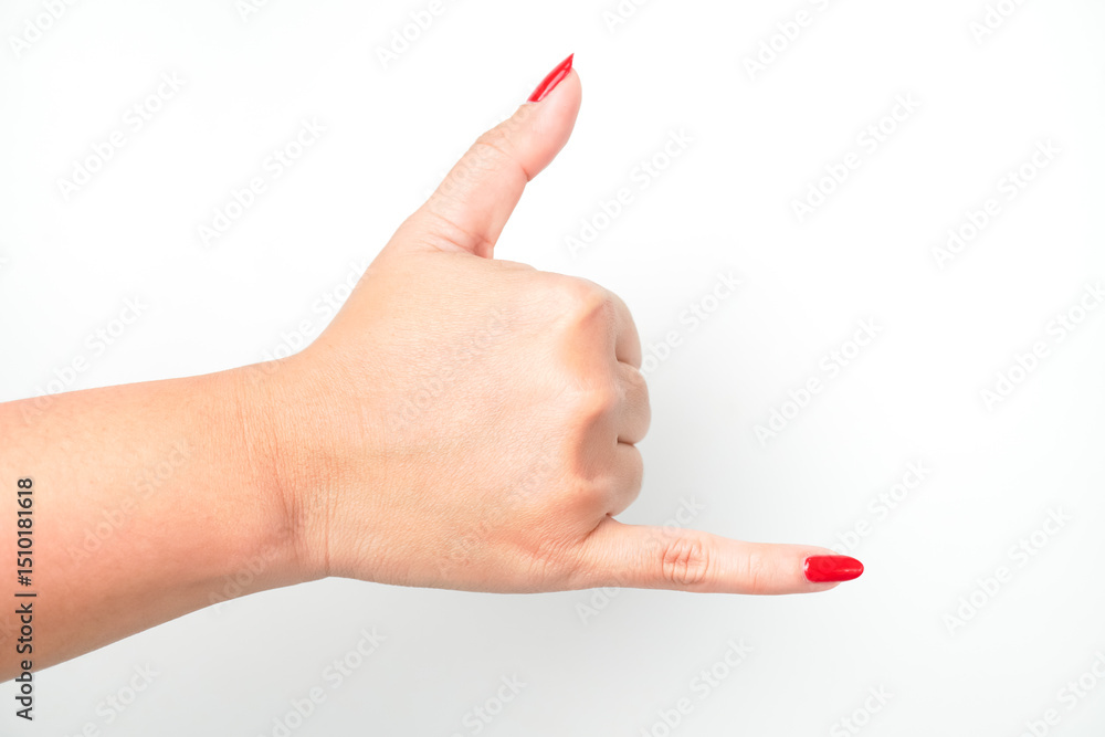 A woman's hand with bright red nail polish forms extending the thumb ...