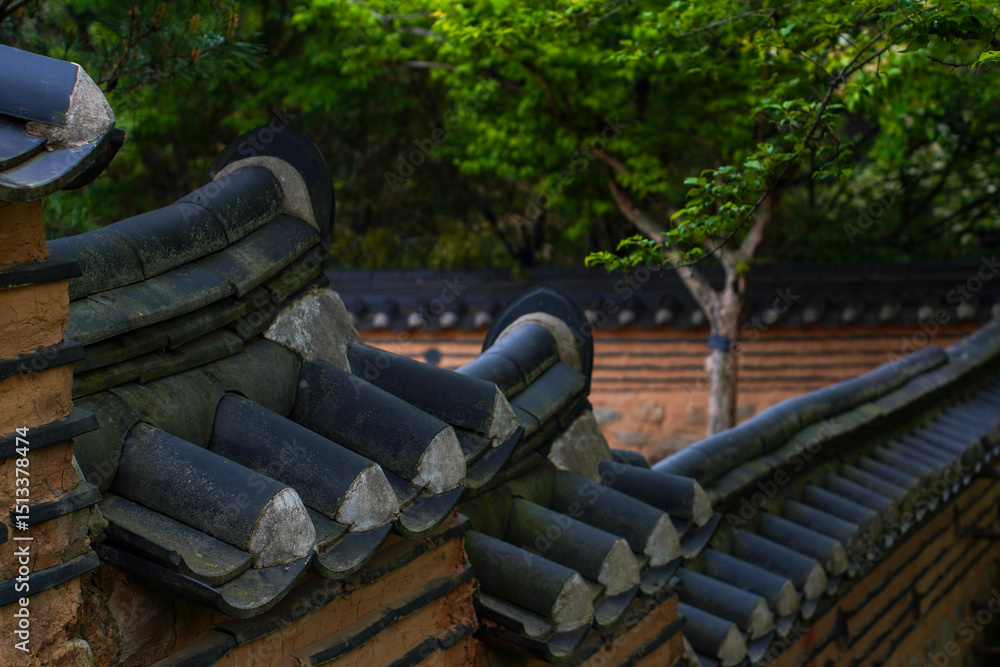 Traditional Korean stone wall topped with dark gray giwa roof tiles ...