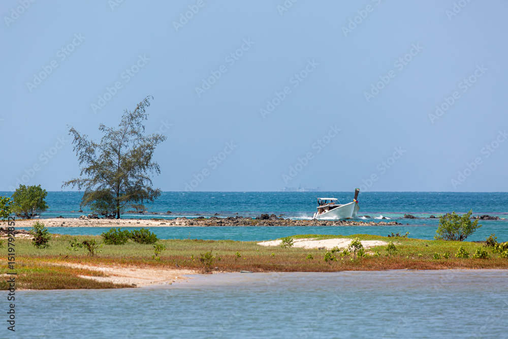 Returning traditional long tailed boat coming back to a beach in Koh ...
