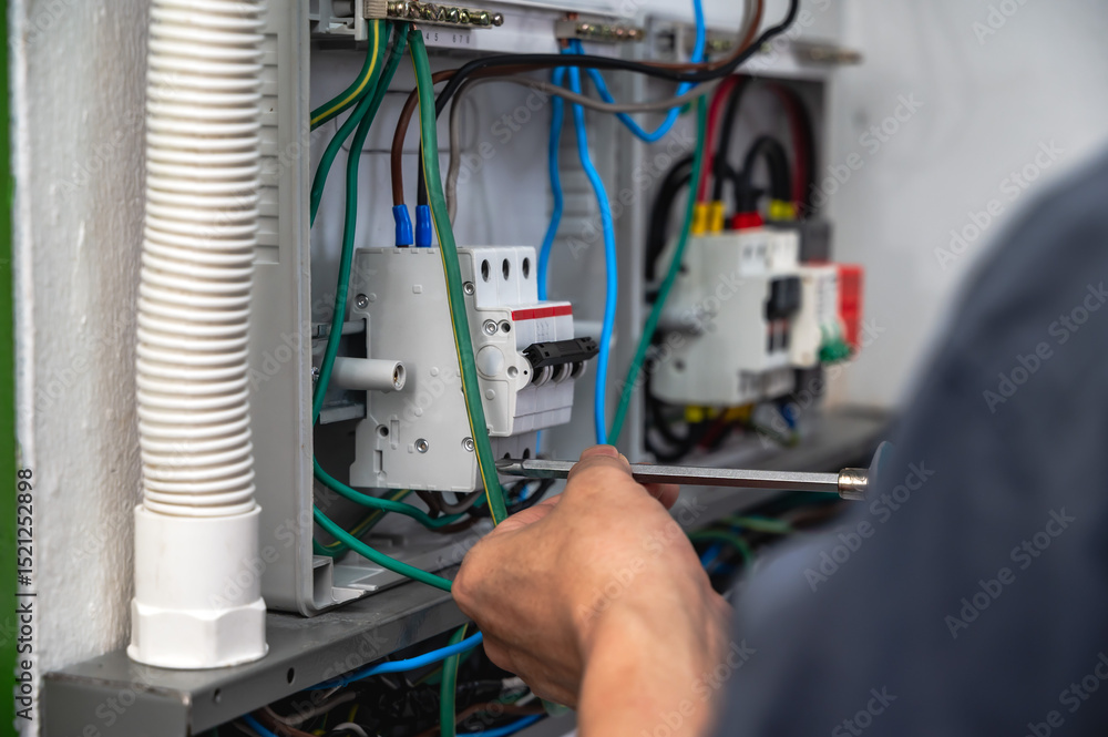 Close up electrician installing combiner box in house Stock Photo ...