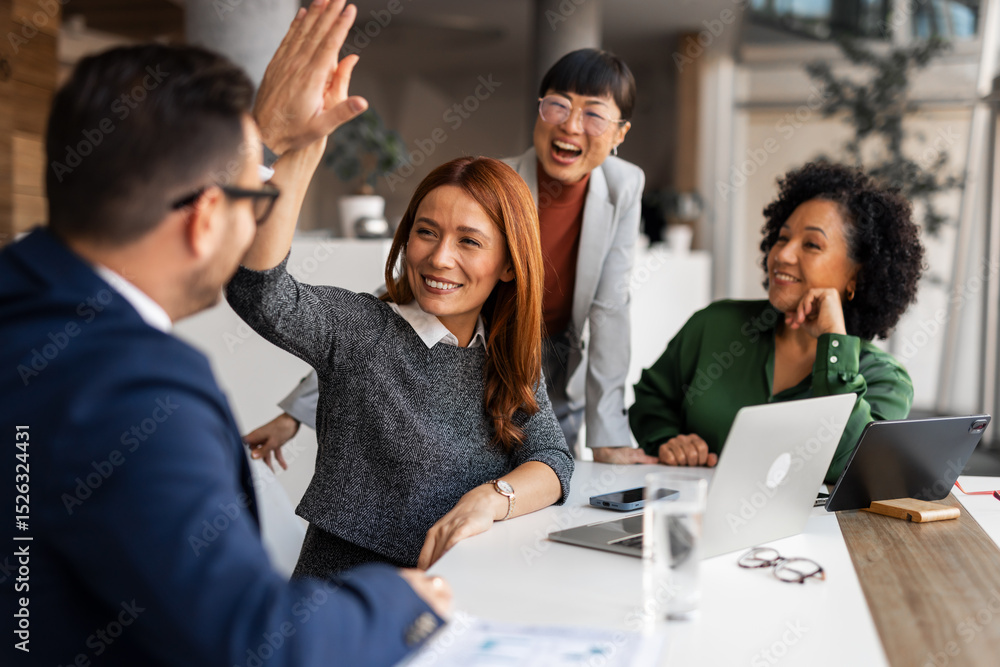 Team Celebrating Success with a High Five Stock Photo | Adobe Stock