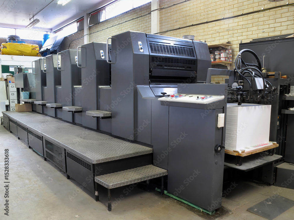 Lithograph printing machine in a factory manufacturing print shop ...