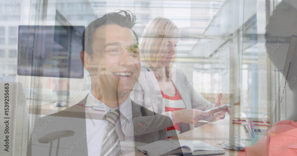 Foto de Stock Working man in grey suit with striped tie typing on ...