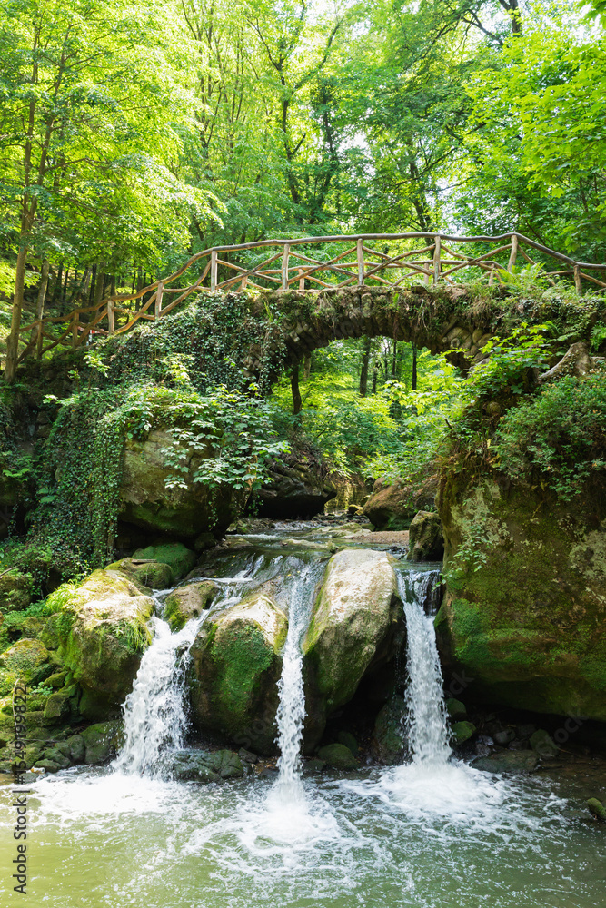 Schiessentuempel waterfall with stone bridge in Mullerthal, Luxembourg ...