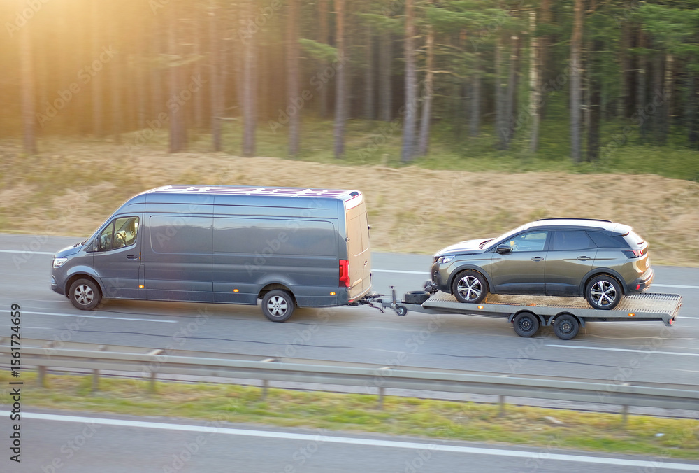 Utility Van Towing SUV on Car Trailer – Vehicle Transport on Highway ...