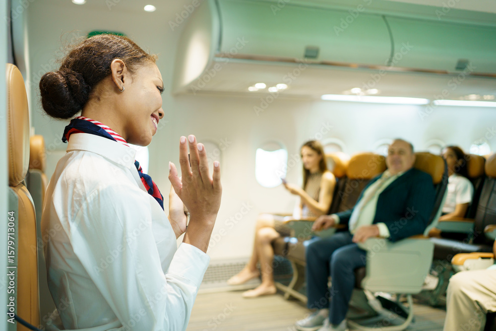 Female cabin crew is perform the flight safety demonstration before ...