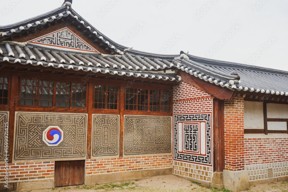 Ornately decorated exterior wall at the Baek In-je House, a preserved ...