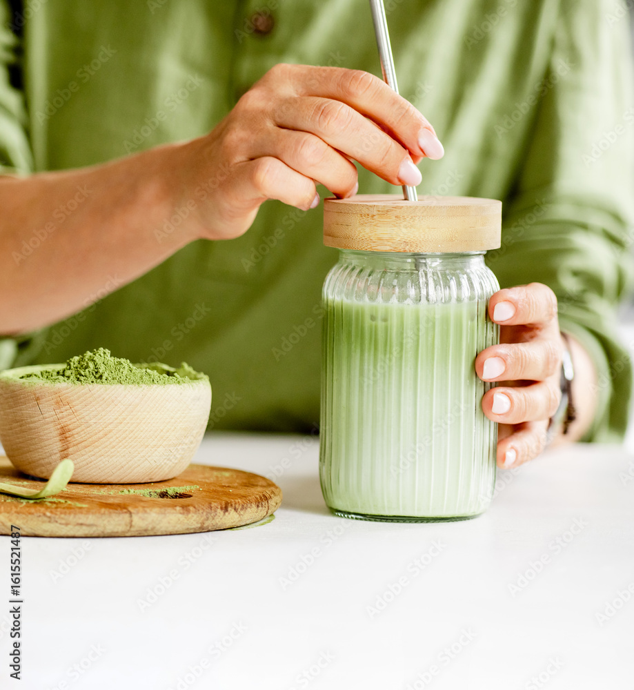 Woman Making Matcha Latte Tea Inserts A Straw Into The Jar Of Finished ...