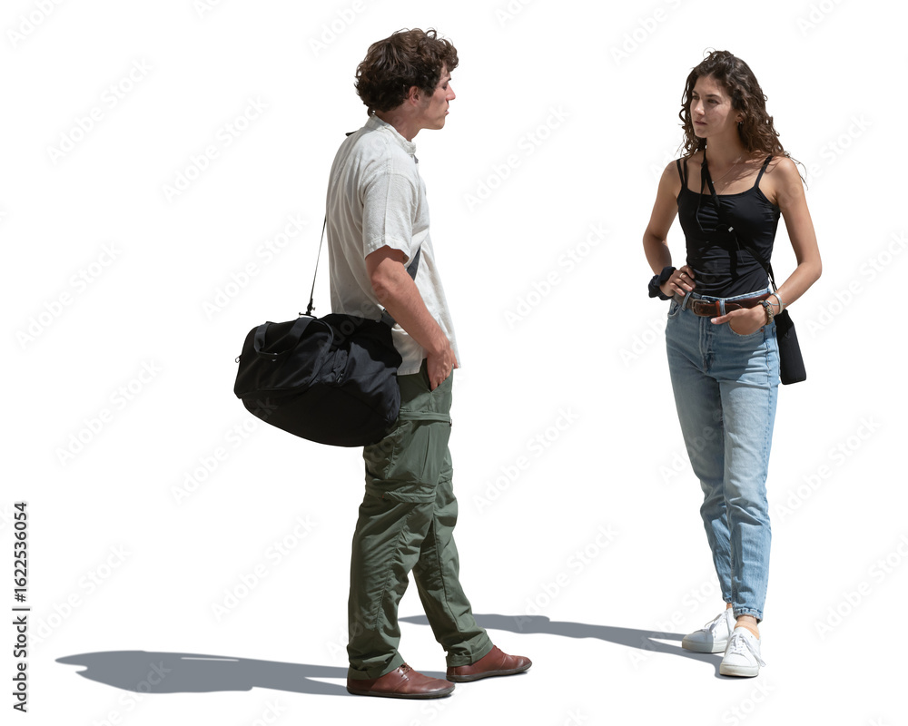 Two people standing casually in the street in sunlight and talking ...