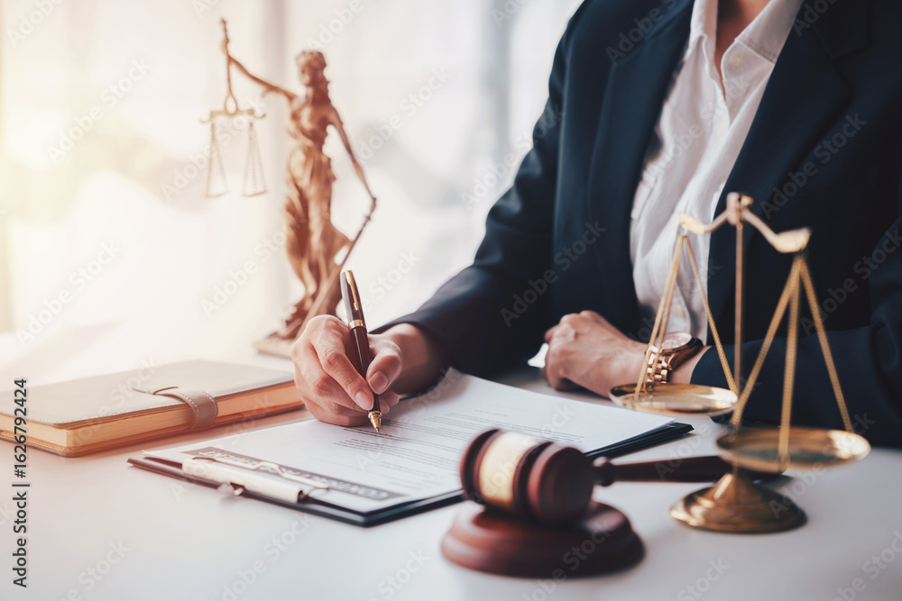 Lawyer Signing Legal Documents in Office with Lady Justice Statue ...