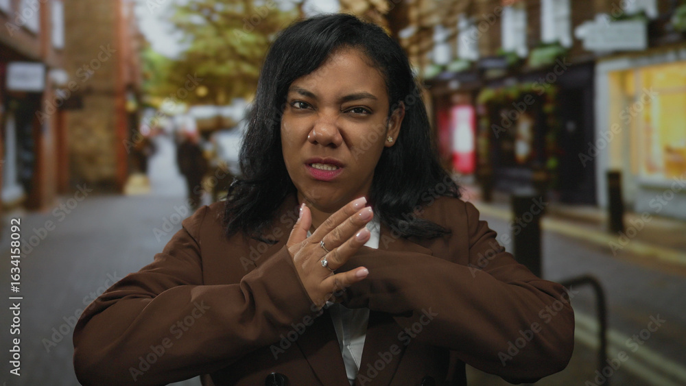 African american woman pounds fist on palm on crowded downtown street ...