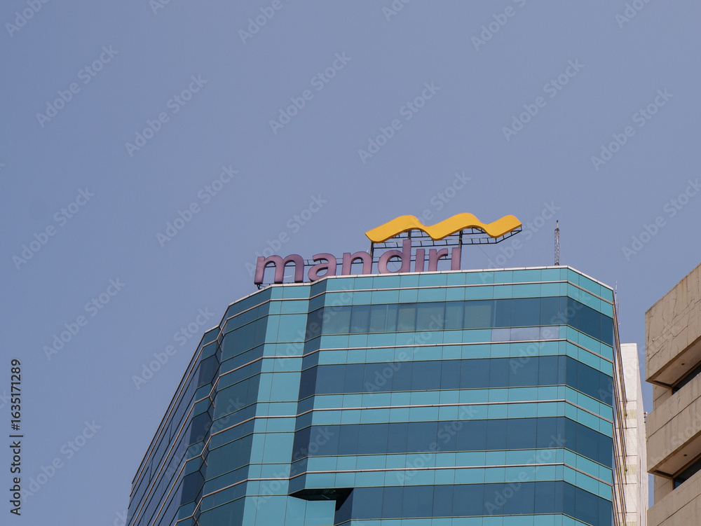 Bank Mandiri office building with glass facade and iconic yellow wave ...