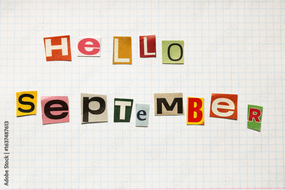 Hello september written with colorful newspaper cutout letters on graph ...