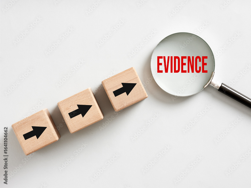 Magnifying glass showing evidence and wooden cubes with arrows pointing ...