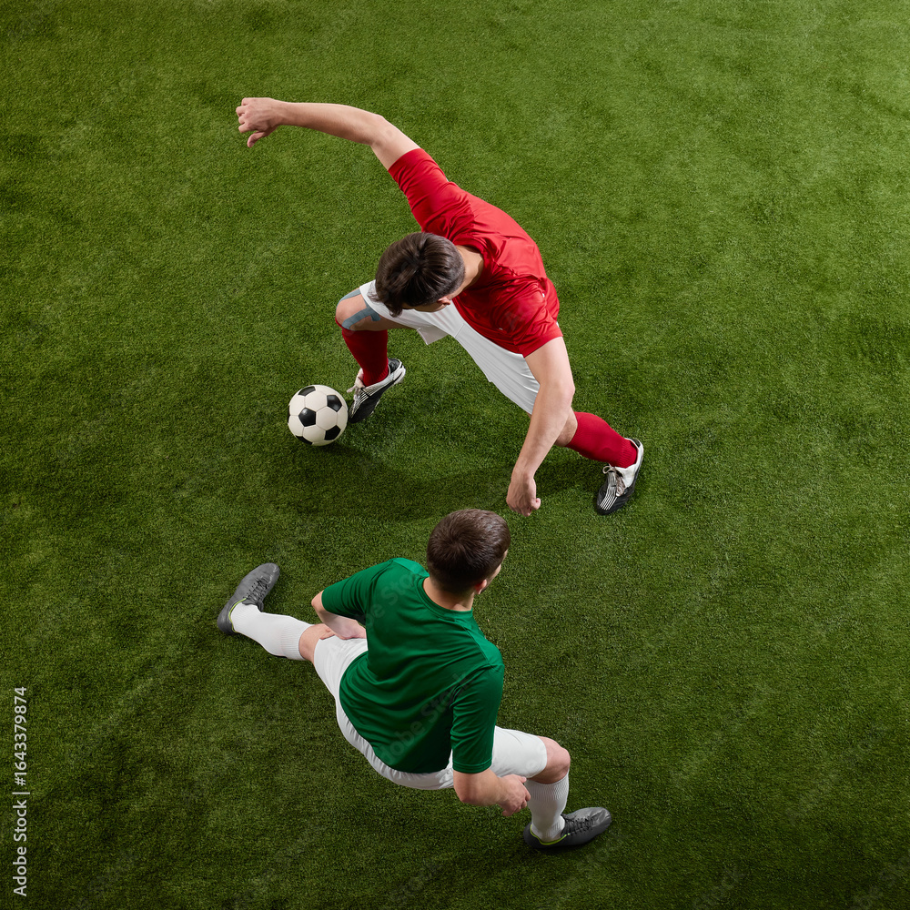 Soccer players in red and green uniforms contest ball on lush green ...