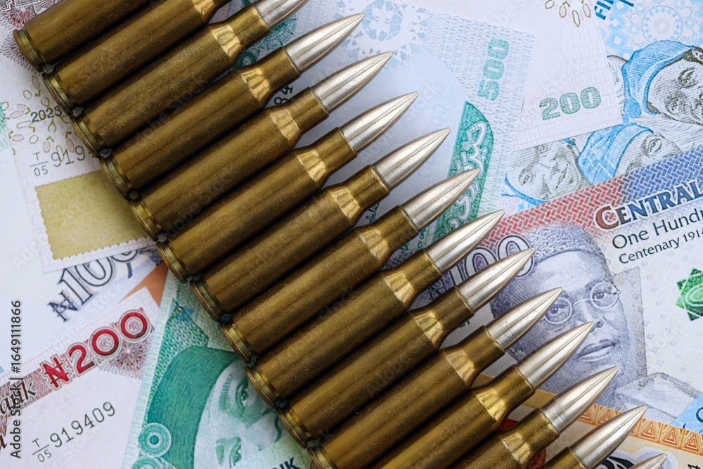 Nigerian naira currency money bills and rifle bullets. The concept of ...