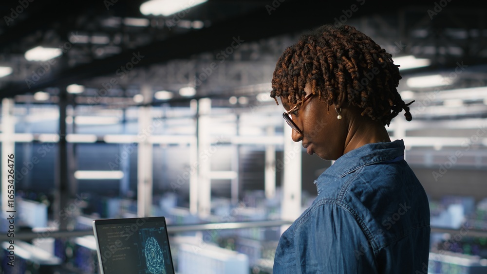 Data center coworkers doing maintenance on mainframes handling AI processing tasks. Server hub ...