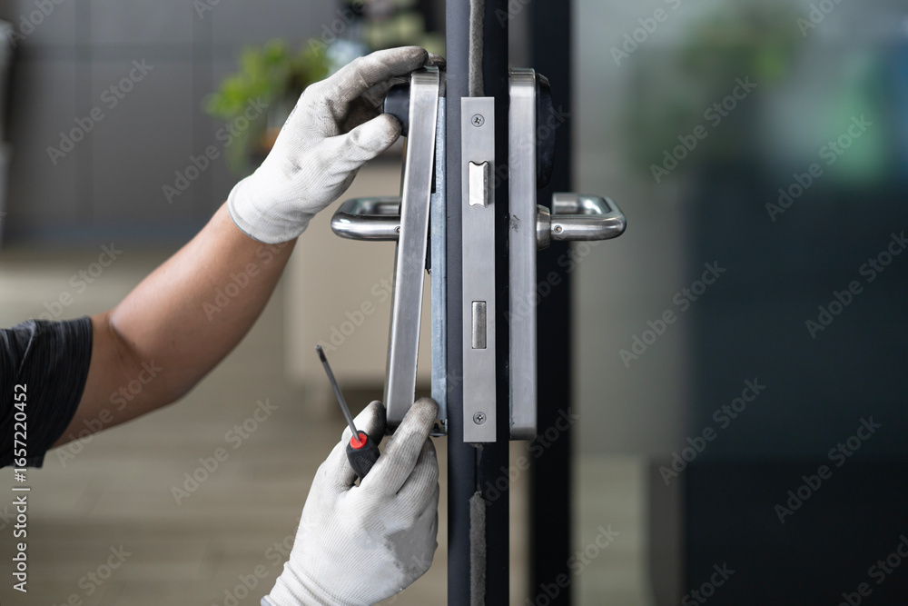 handymen using screwdriver to fix the door lock in the room Stock Photo ...