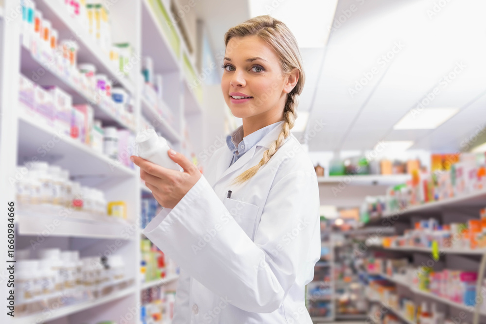 Female pharmacist wearing white lab coat in pharmacy aisle checking ...